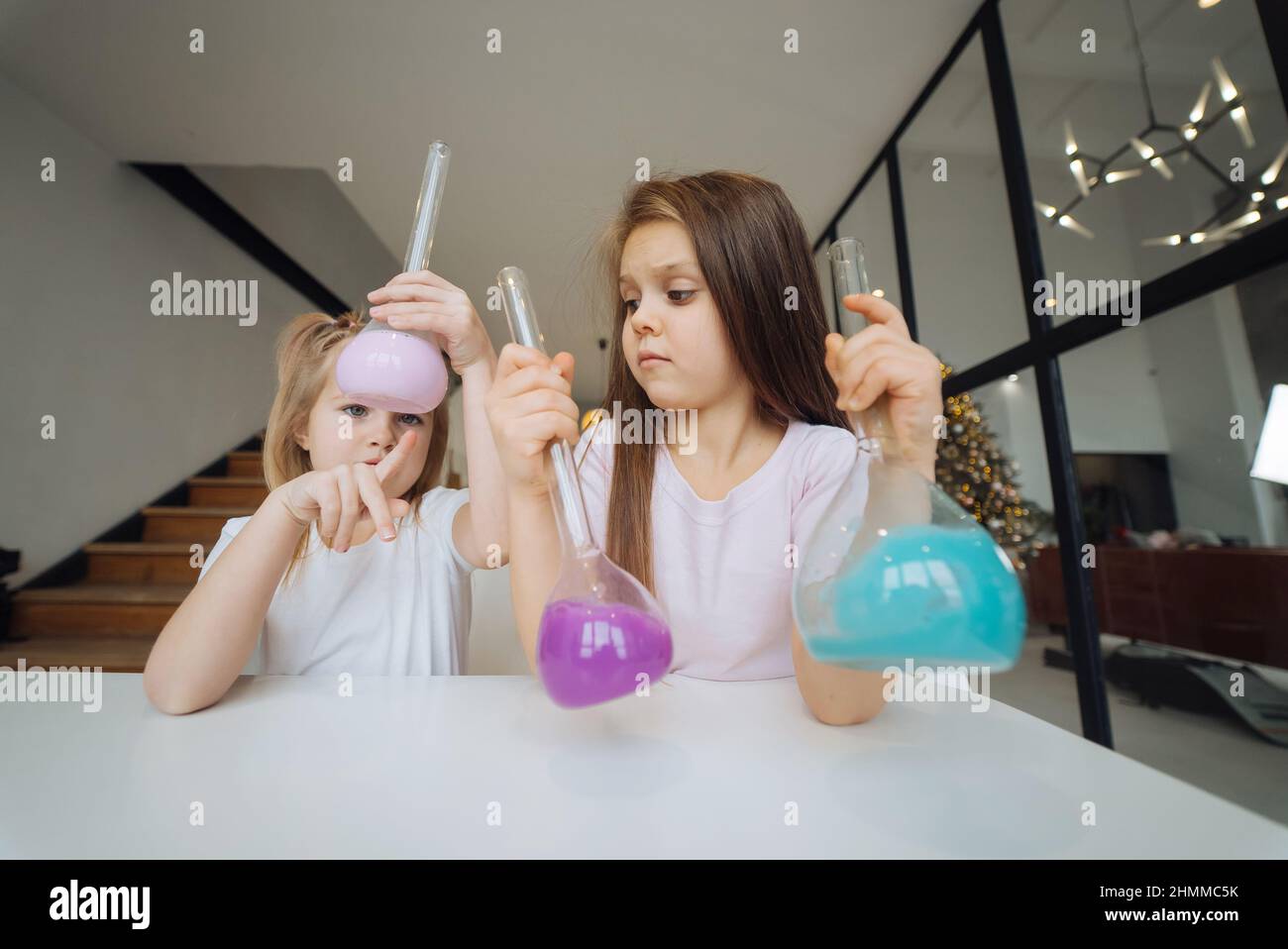 Little girls making chemical experiments at home Stock Photo - Alamy