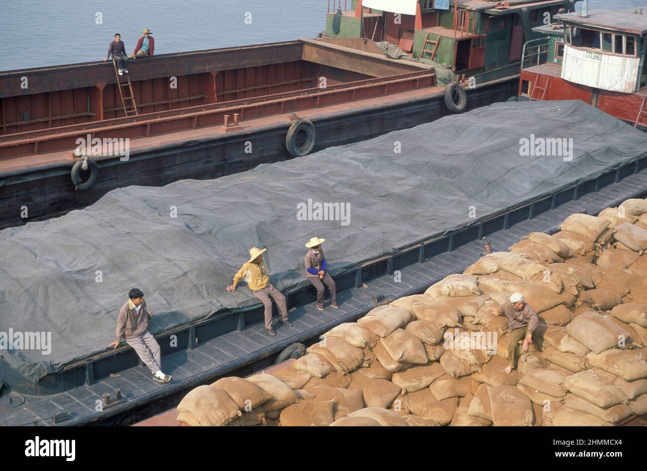 Worker offload Sand for Construction off a Transport ship at the ...