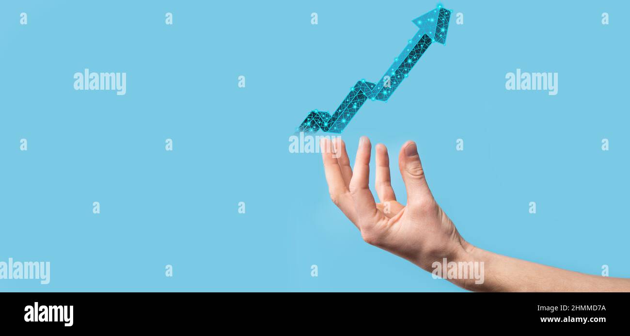 Businessman hold graph, arrow of positive growth icon.pointing at ...