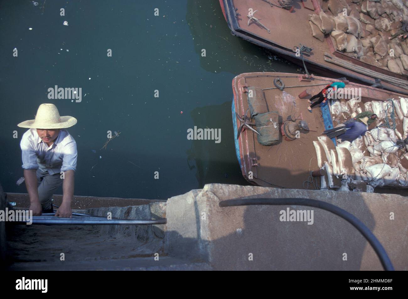 Worker offload Sand for Construction off a Transport ship at the ...