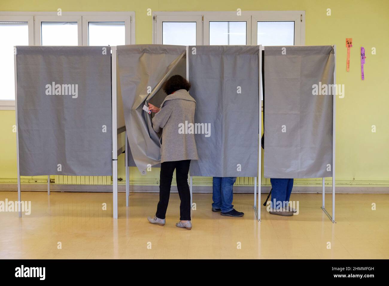 Polling station: woman entering a polling booth to place her ballot ...