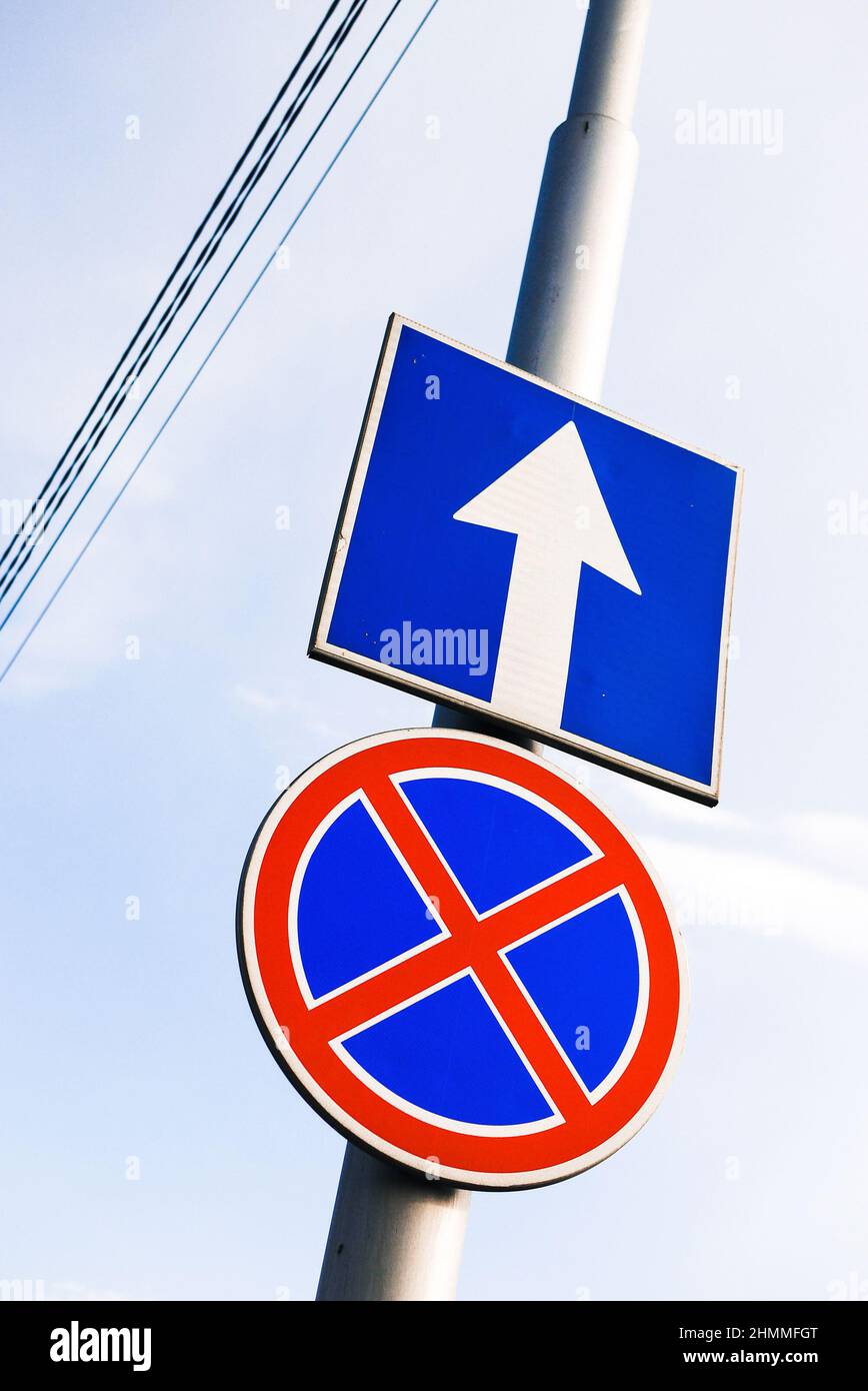 Red and blue road sign view against the sky Stock Photo - Alamy