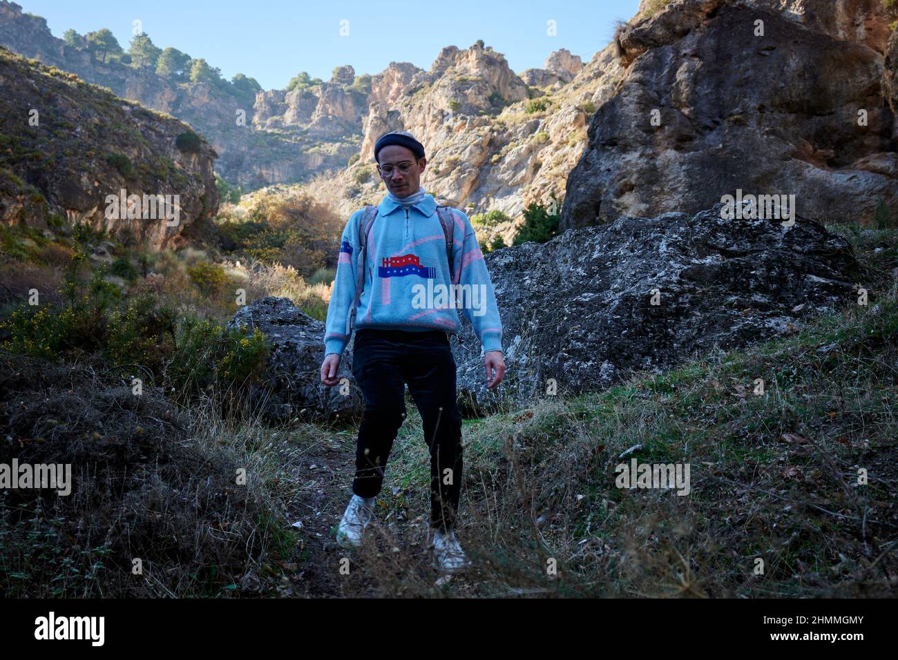 German male hiker trailing down a hill Stock Photo - Alamy