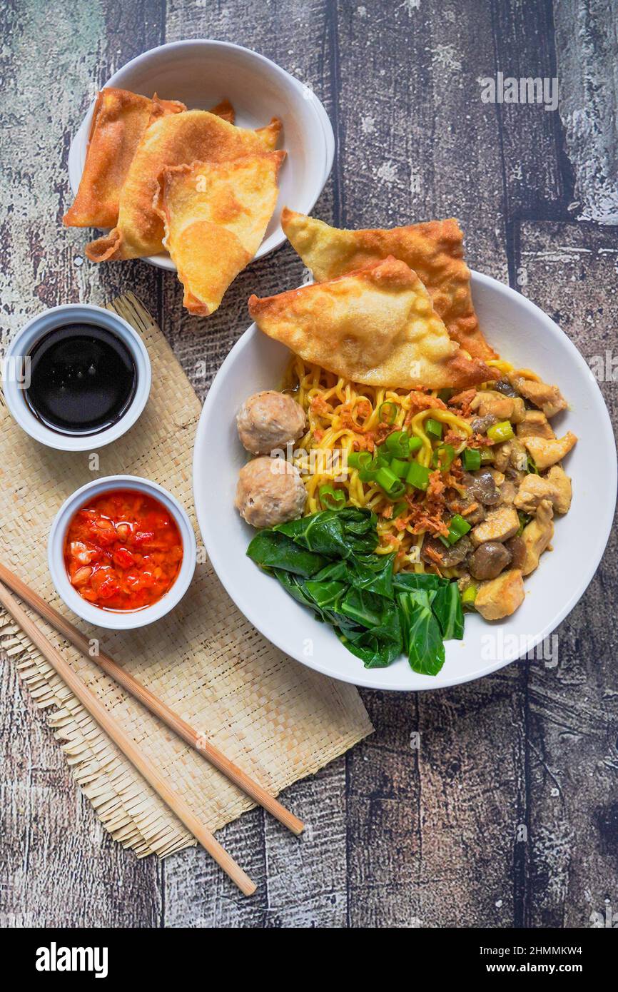 Indonesian famous street food Mie Ayam or chicken noodles served with ...