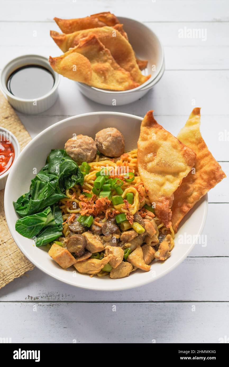 Indonesian famous street food Mie Ayam or chicken noodles served with ...