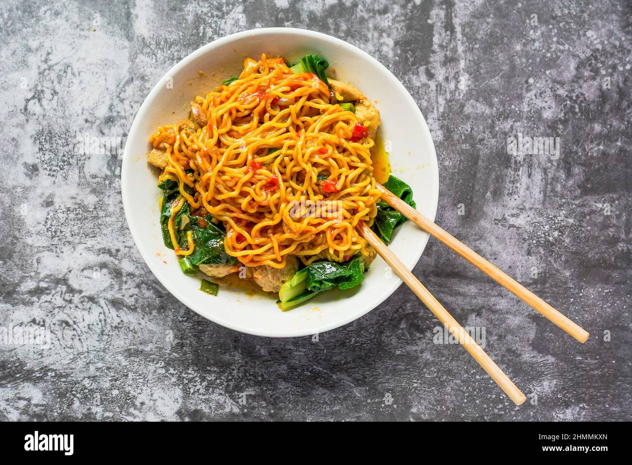 Indonesian famous street food Mie Ayam or chicken noodles served with ...
