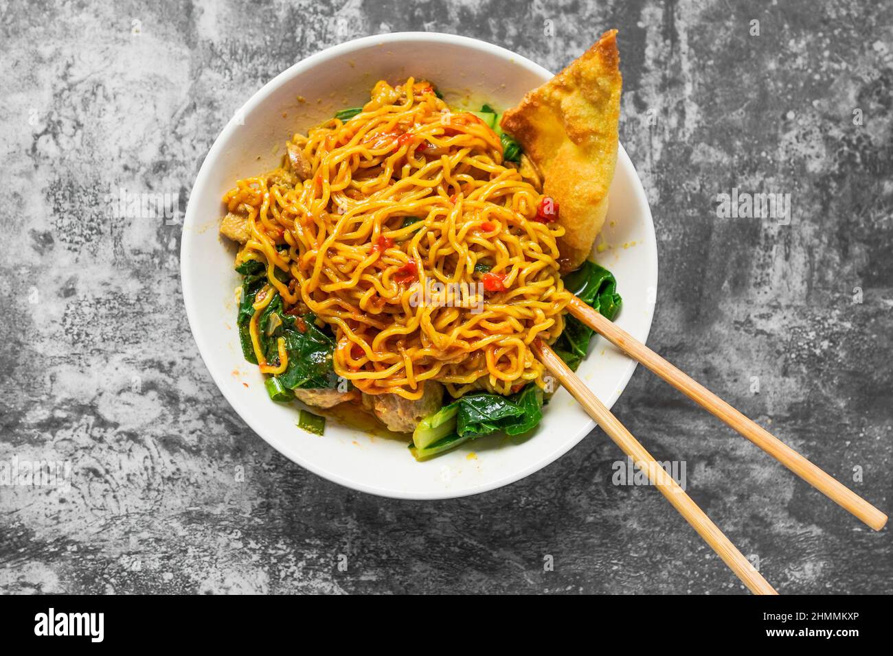 Indonesian famous street food Mie Ayam or chicken noodles served with ...