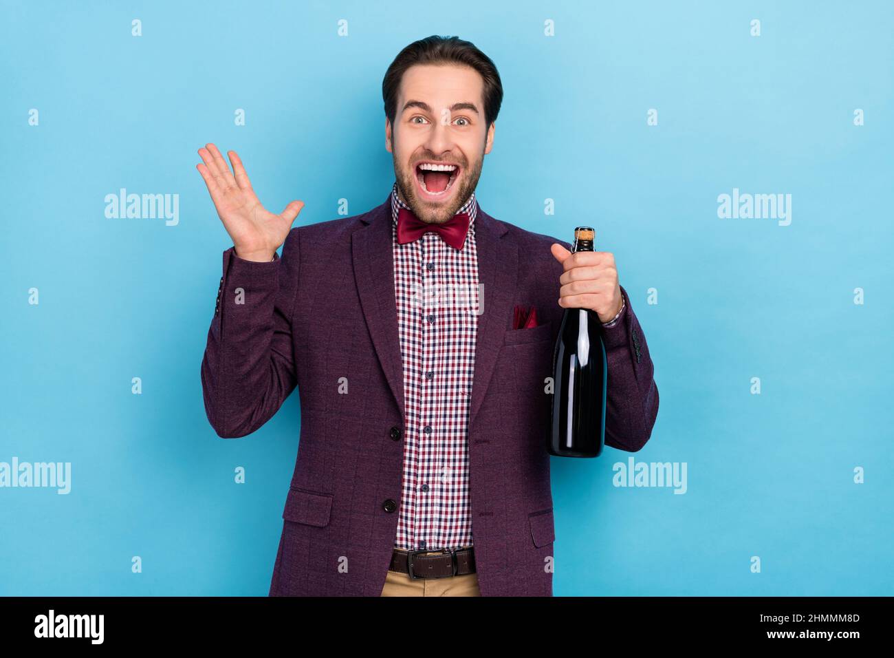 Photo of young astonished man celebrate event festive champagne ...