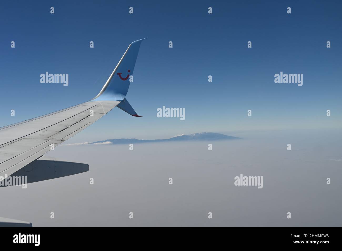 A wing of a Boeing 737 TUI chartered airplane taken in flight showing ...