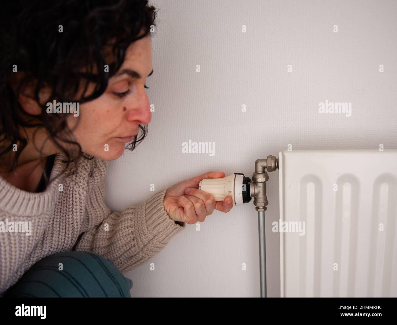 Turning down heating woman hi-res stock photography and images - Alamy