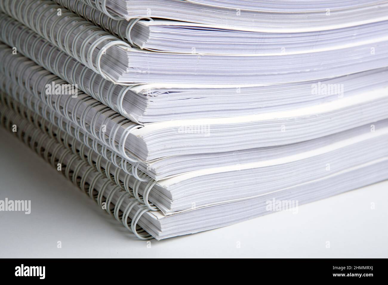 stack of large white notebooks on the desktop close up Stock Photo - Alamy