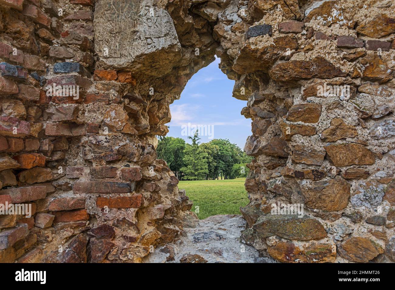 Beautiful field view and the ancient window of an old ruined castle ...