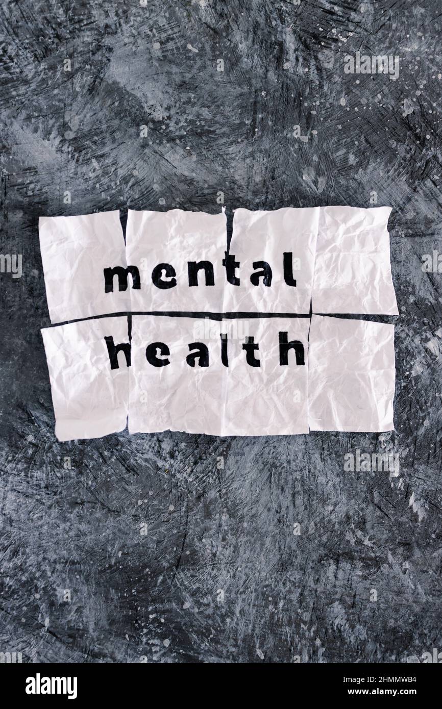 Mental health text on crumpled and torn piece of paper which has been ...