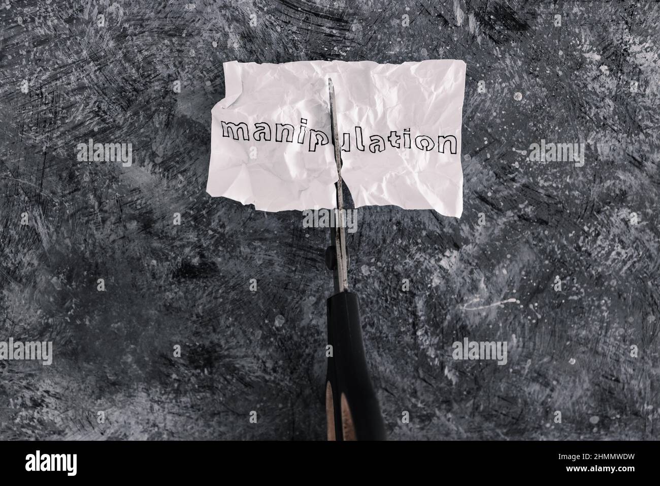 Manipulation text on crumpled piece of paper which is getting cut with ...