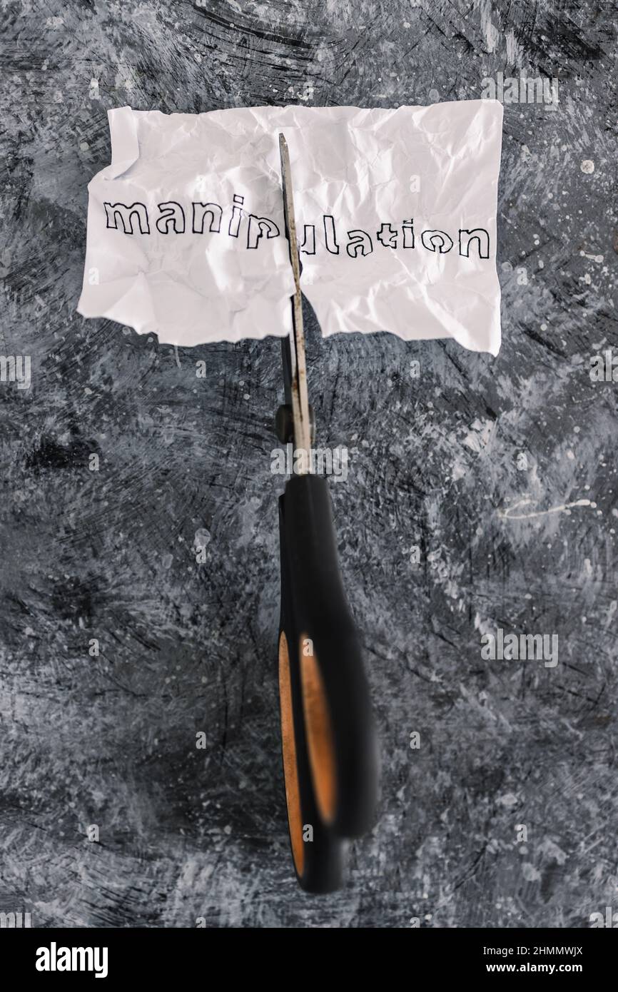 Manipulation text on crumpled piece of paper which is getting cut with ...