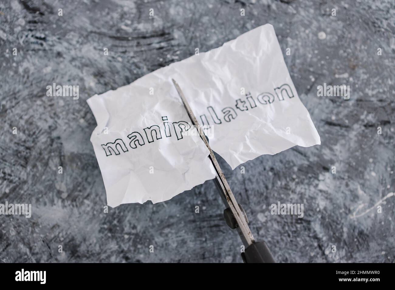 Manipulation text on crumpled piece of paper which is getting cut with ...