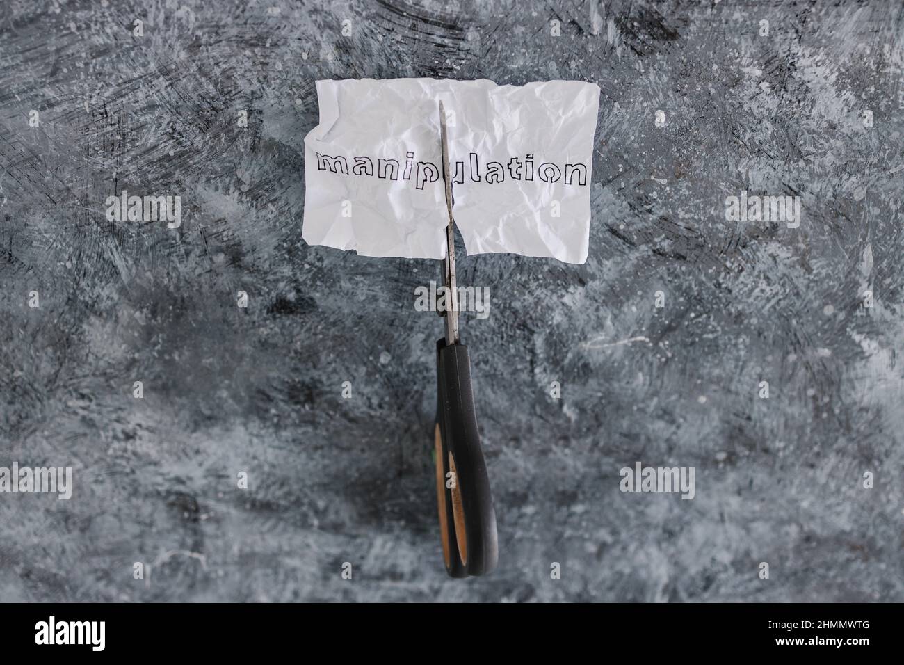 Manipulation text on crumpled piece of paper which is getting cut with ...