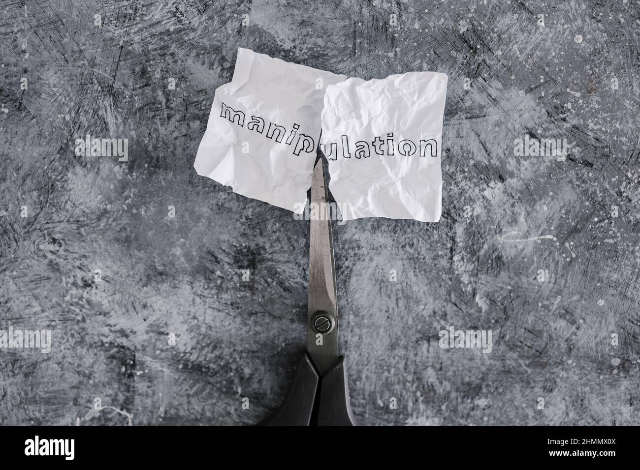 Manipulation text on crumpled piece of paper which is getting cut with ...