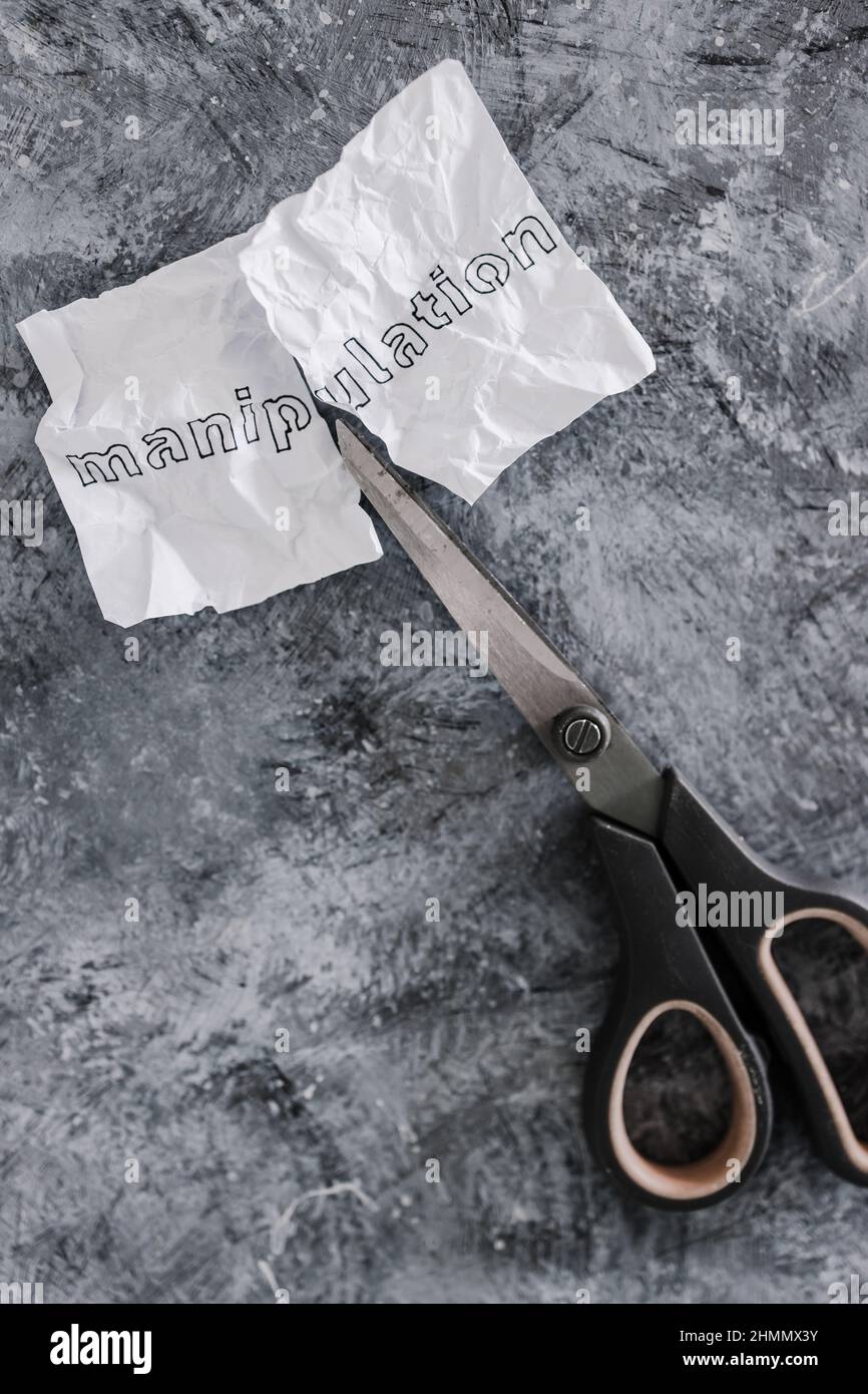 Manipulation text on crumpled piece of paper which is getting cut with ...