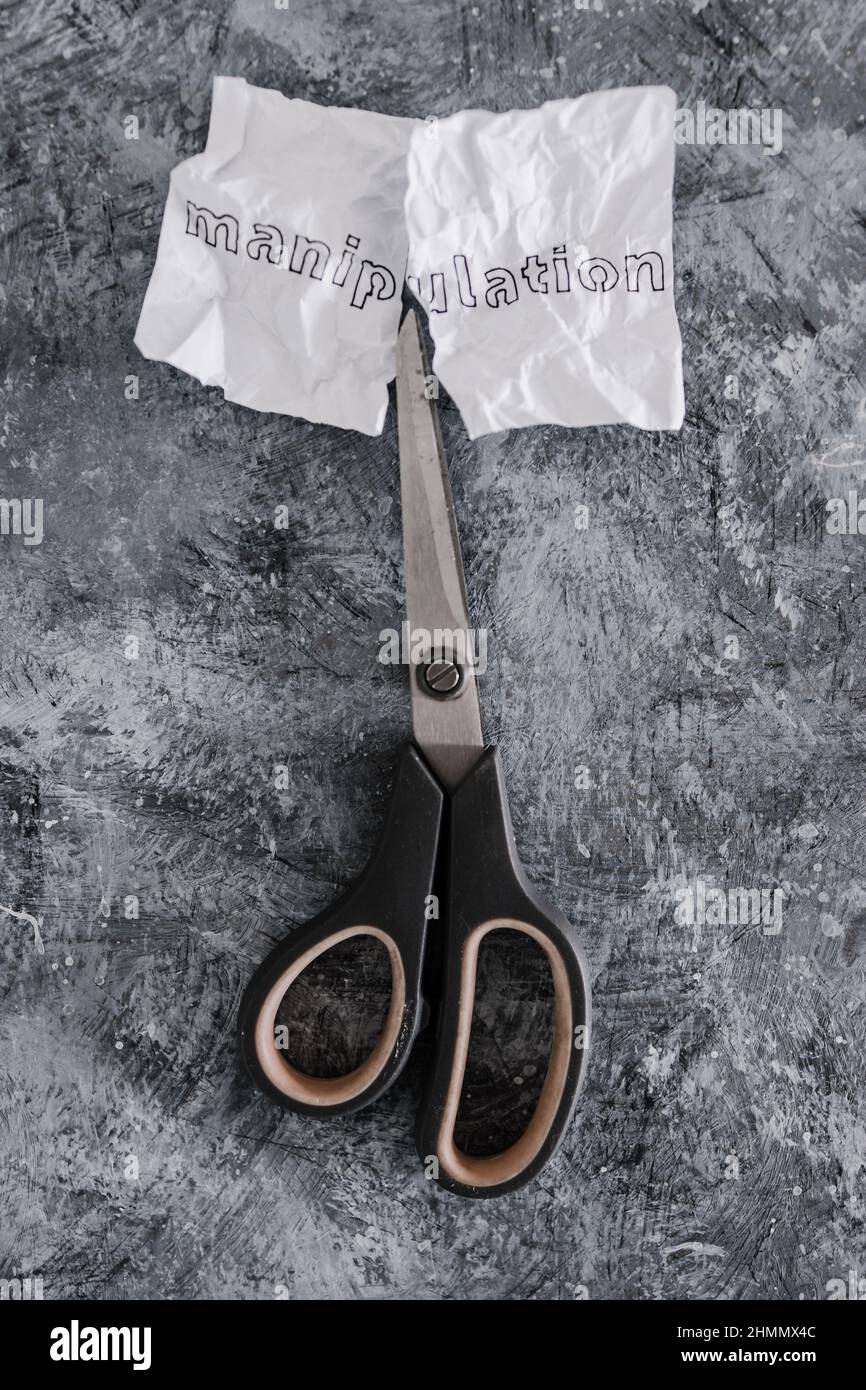 Manipulation text on crumpled piece of paper which is getting cut with ... Manipulation text on crumpled piece of paper which is getting cut with ...