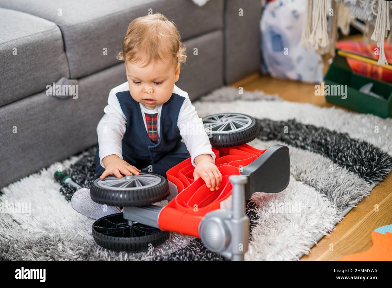 Cute little baby boy playing and repairing his first bike Stock Photo ...