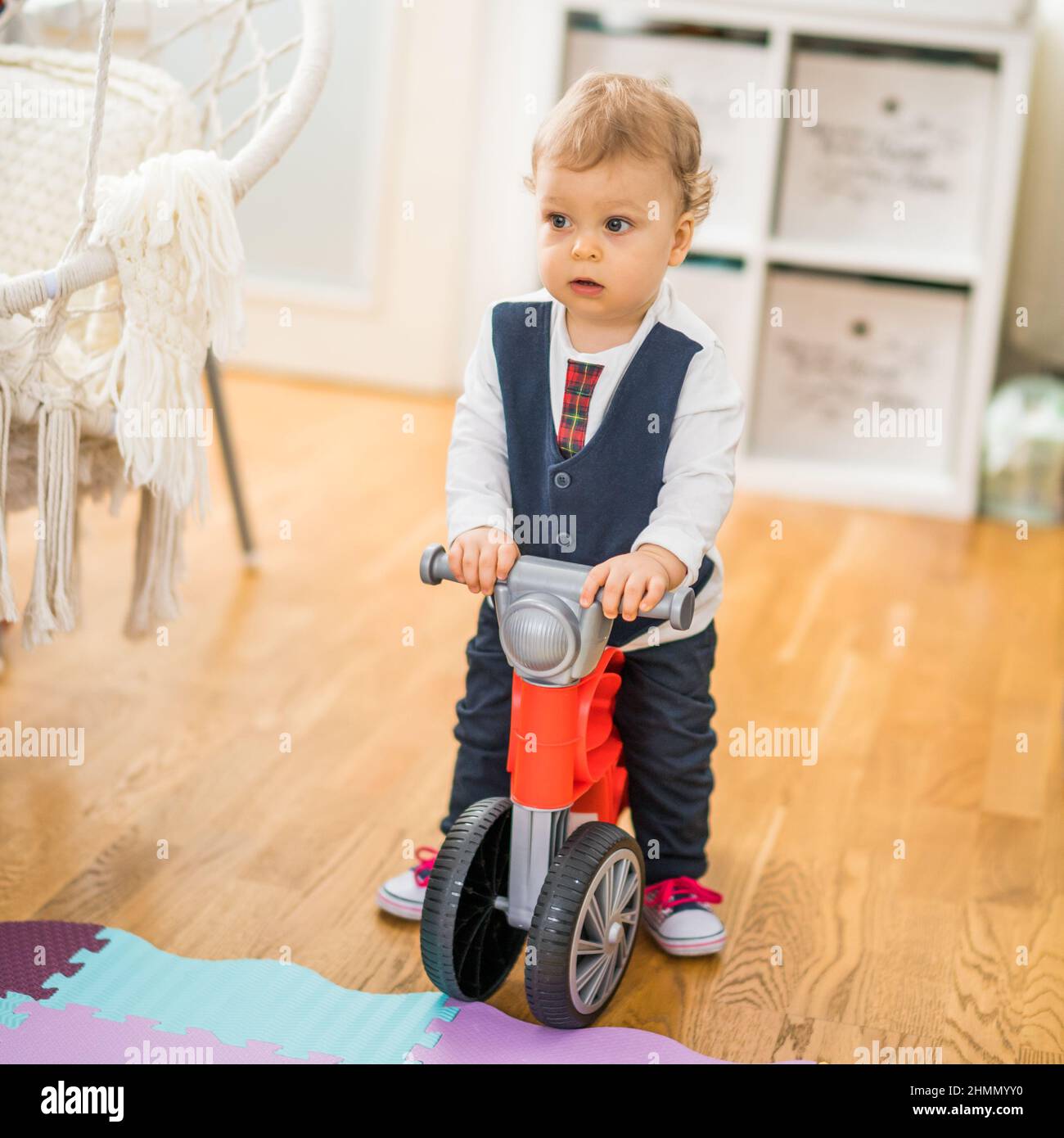 Image of cute little baby boy riding his first bike Stock Photo - Alamy
