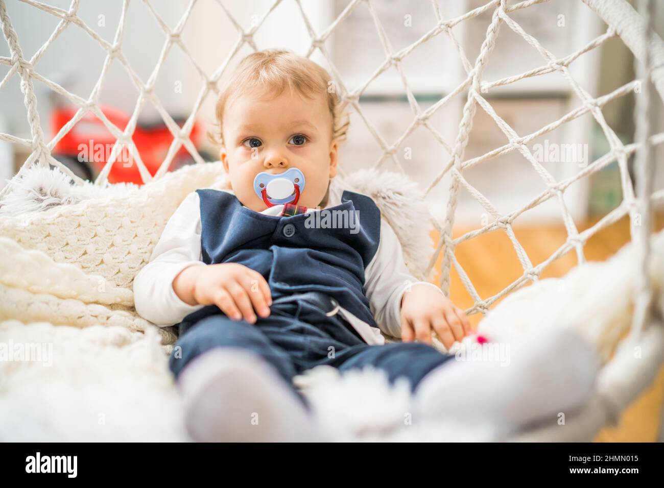 Image of cute baby boy with pacifier sitting Stock Photo - Alamy