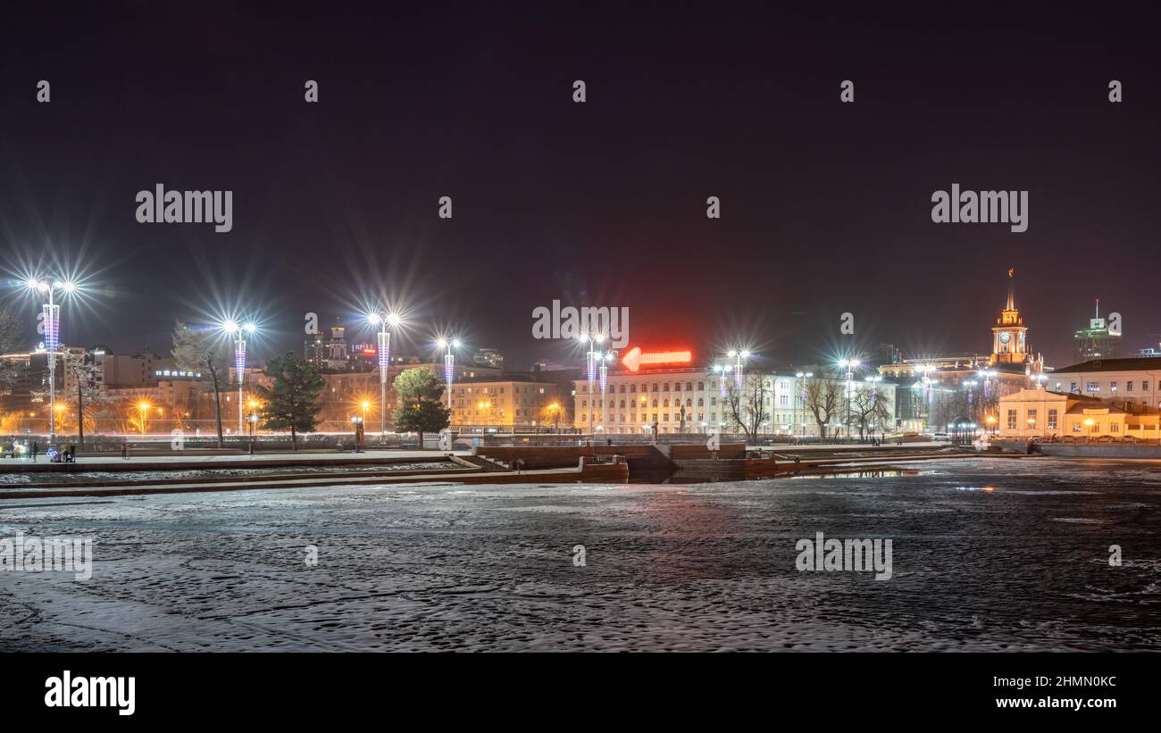 Early Spring night on the banks of the pond in the city center ...