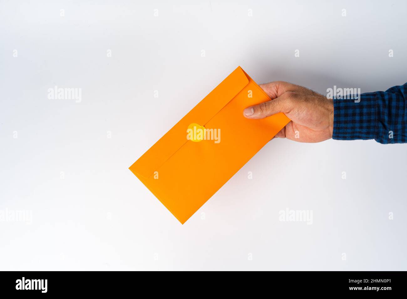 Male hand holding closed envelope above the white surface Stock Photo ...