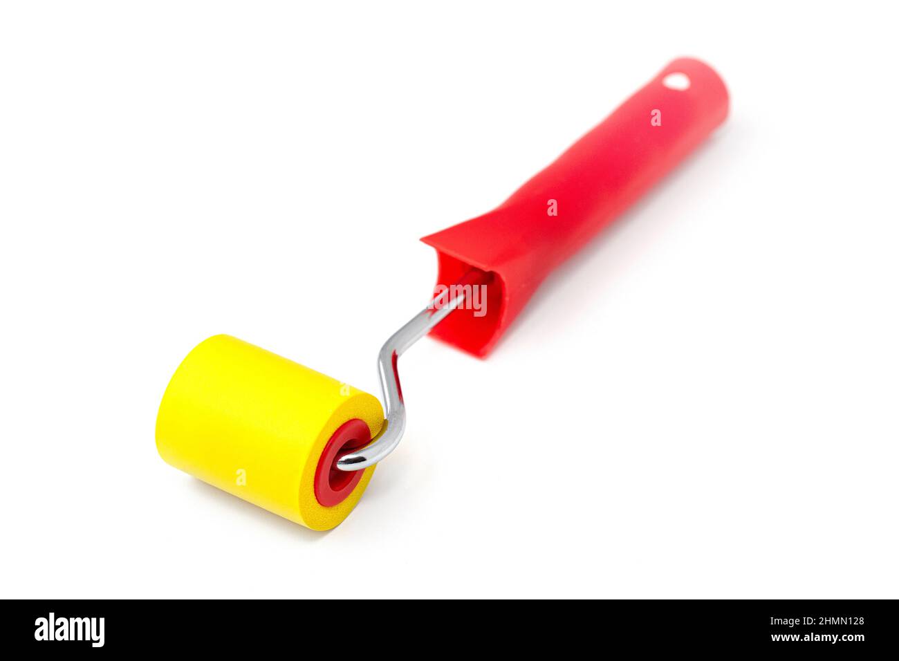 Yellow rubber paint roller on a white background Stock Photo - Alamy