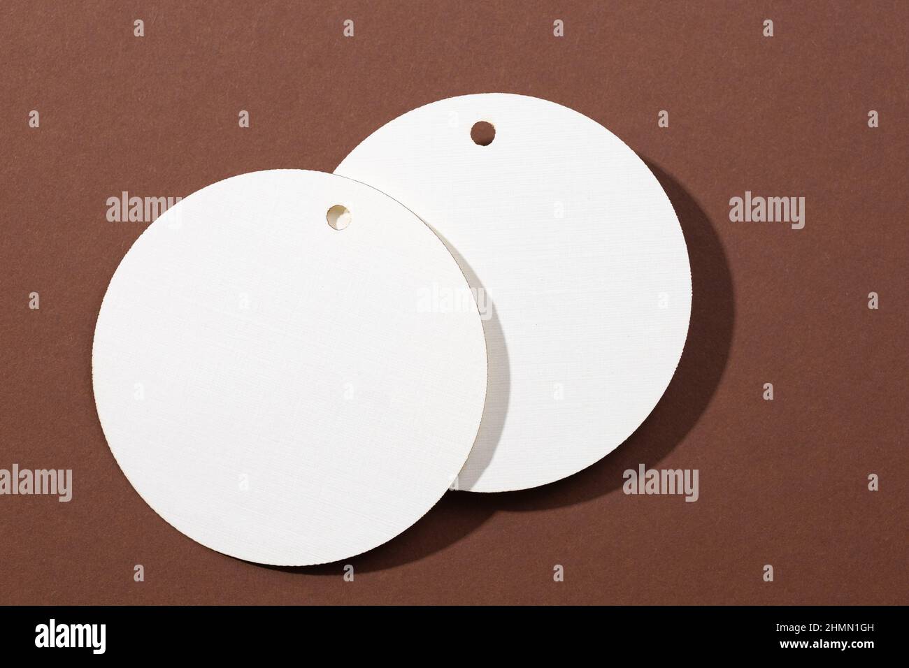 White cardboard blank circle tags of same size with little holes in ...