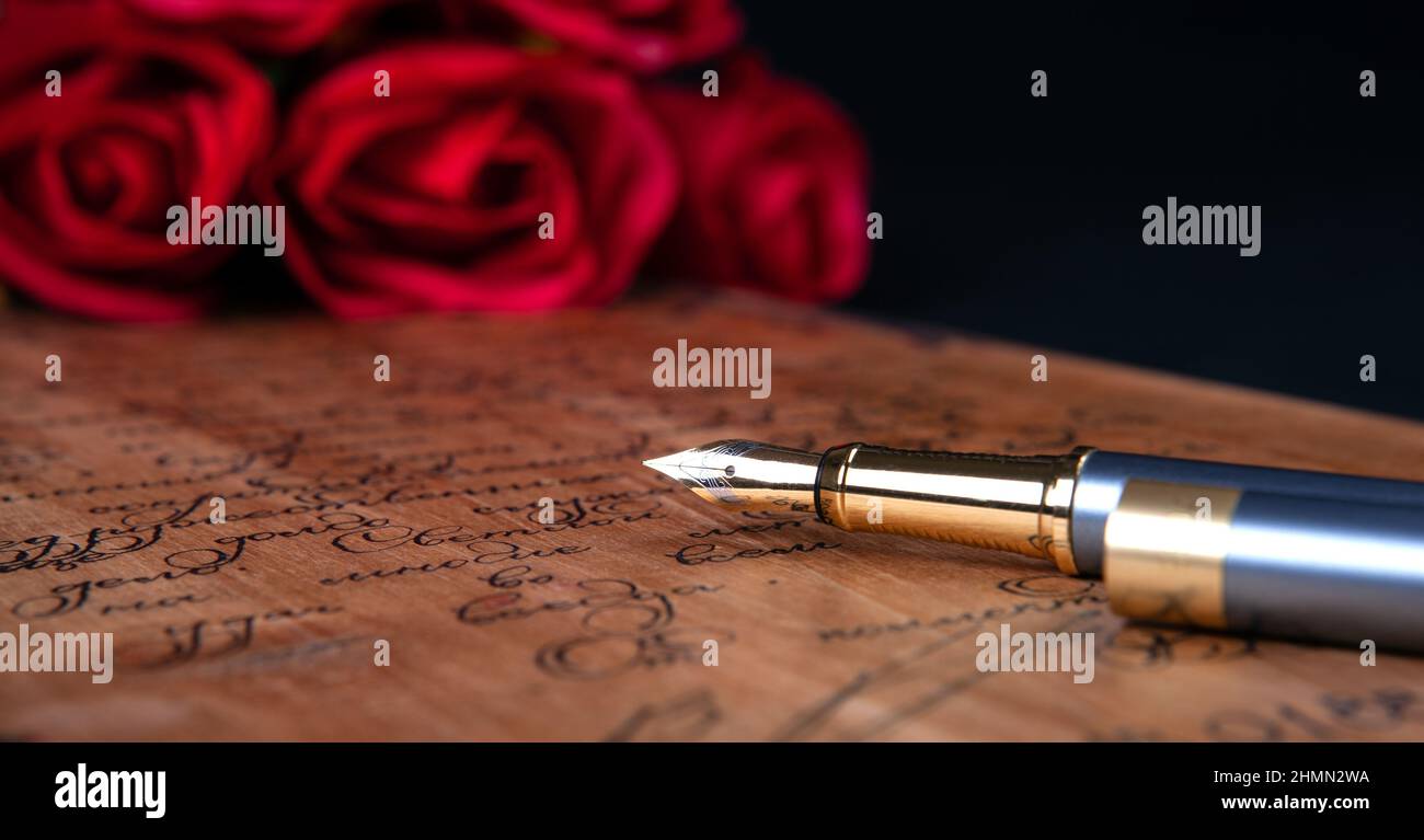 fountain pen on letter with text and red roses close up Stock Photo - Alamy
