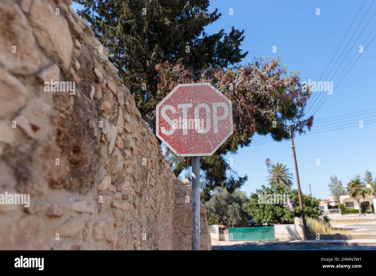 old stop sign on the street of Cyprus in summer Stock Photo - Alamy