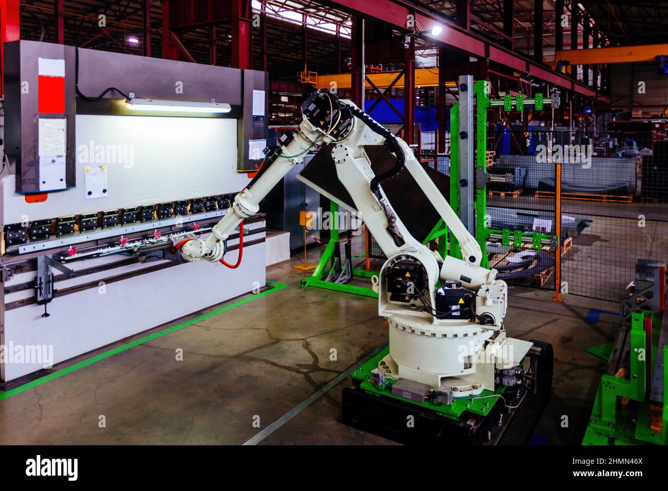 Robotic arm working with metal sheet at hydraulic bending machine Stock ...