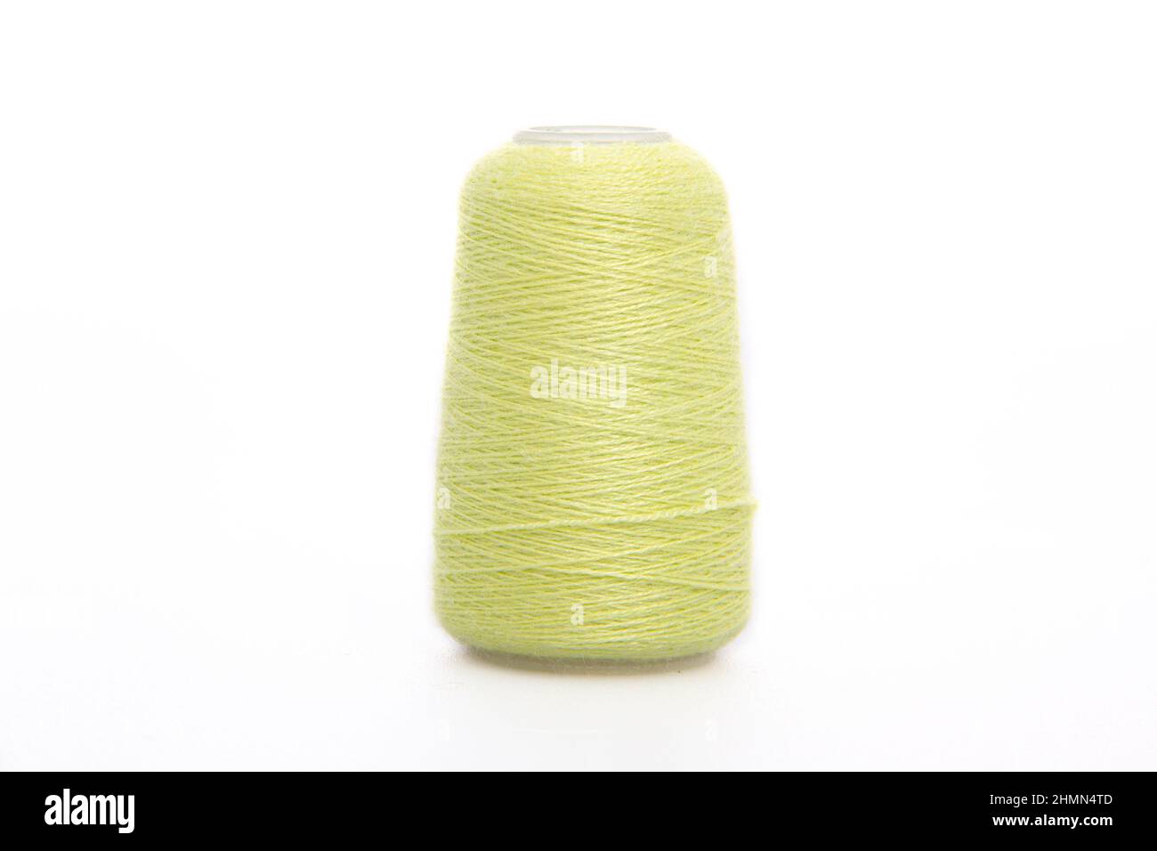 Yellow spool of thread isolated on white background. Skein of woolen ...