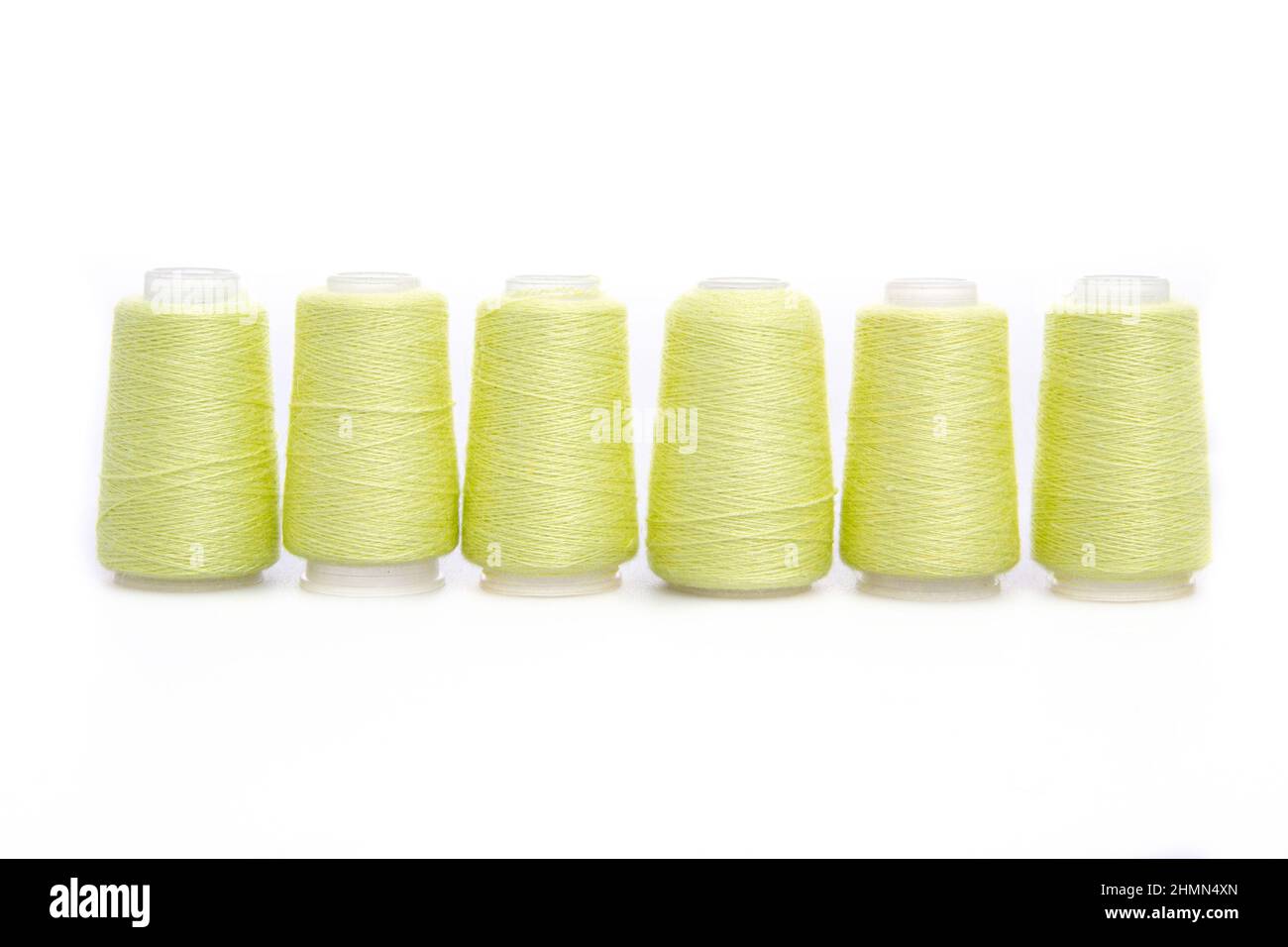 Yellow spool of thread isolated on white background. Skein of woolen ...