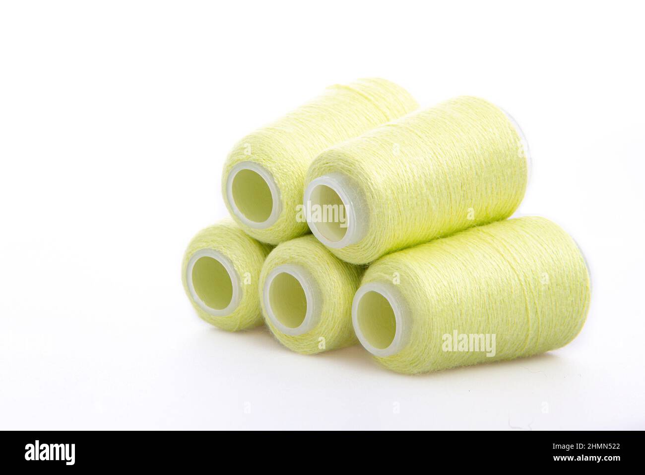 Yellow spool of thread isolated on white background. Skein of woolen ...