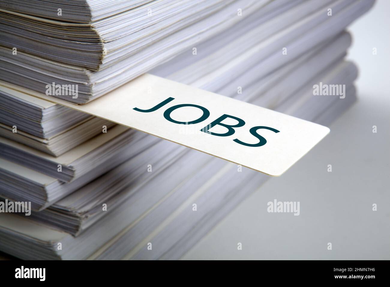 stack of documents and a bookmark labeled job search close up Stock ...