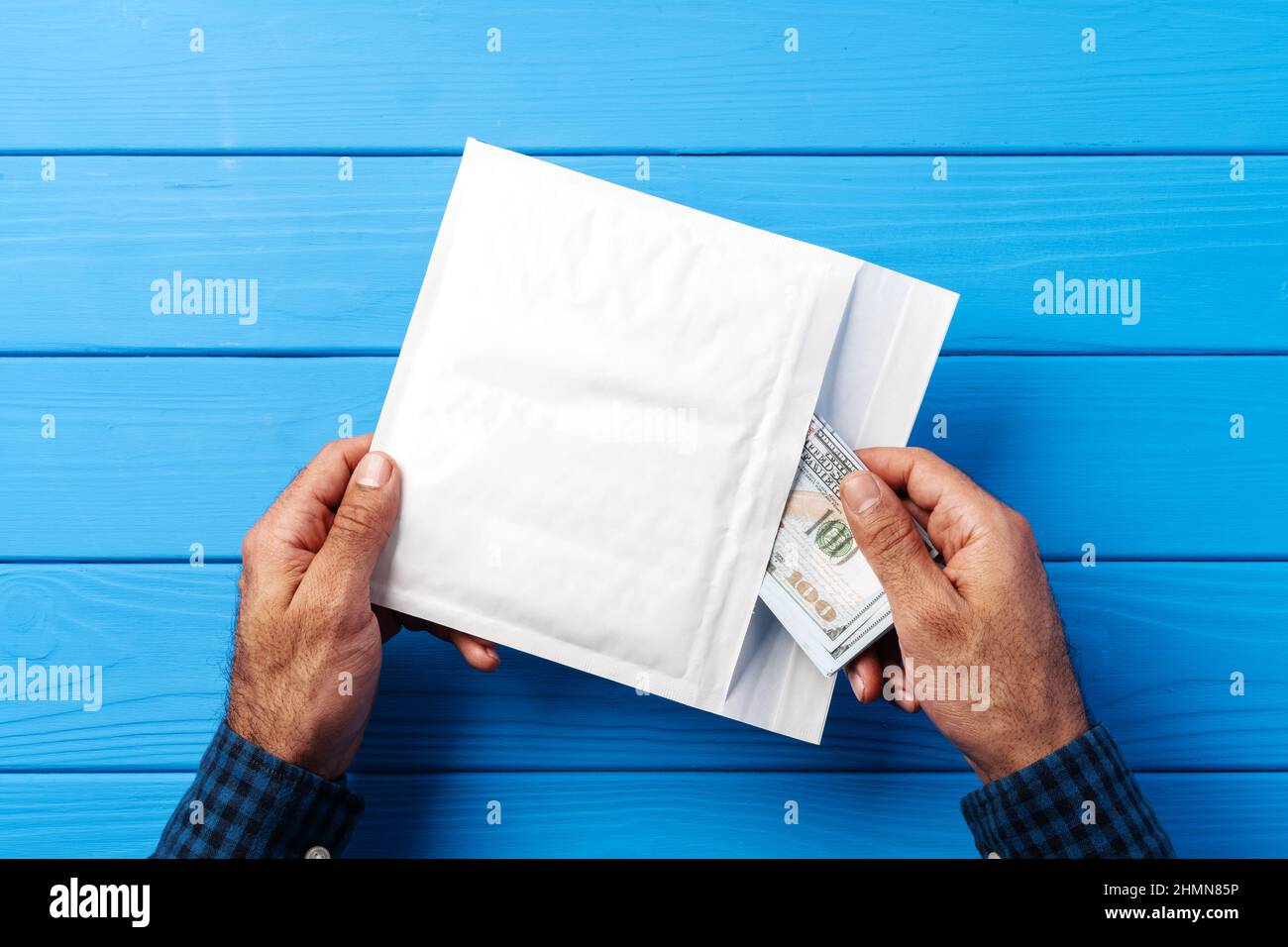 Male hands packing money in bubble envelopes for shipping Stock Photo ...