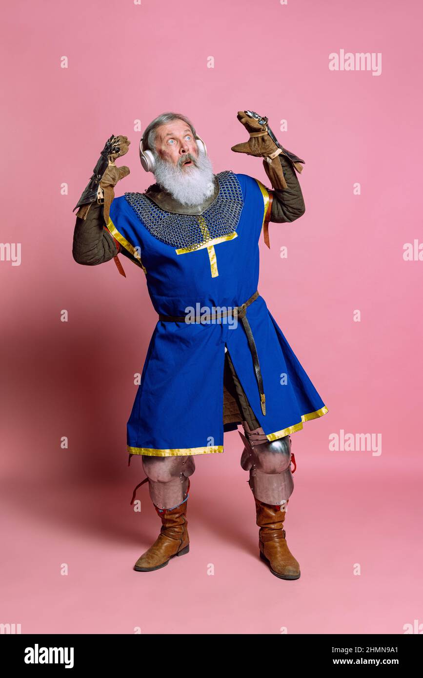 Senior grey bearded man, brave medieval warrior or knight in armored ...