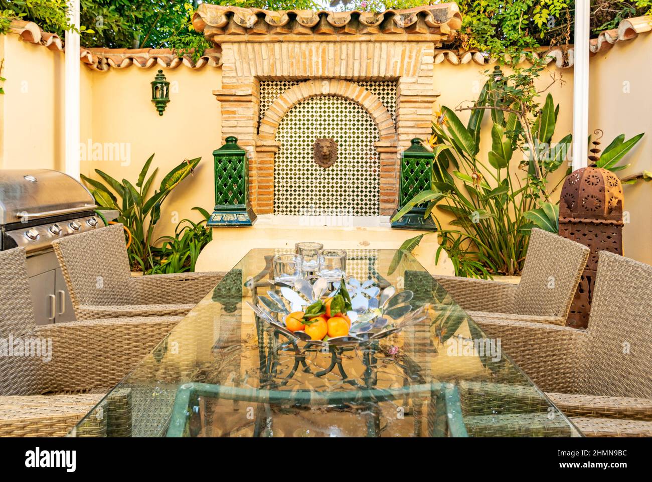 a image of a outdoor dining table with a water fountain feature in the ...