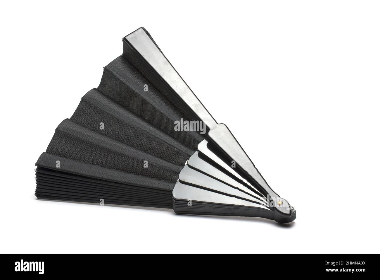 Close up of half closed lying black classic fan to fan cool air on hot ...