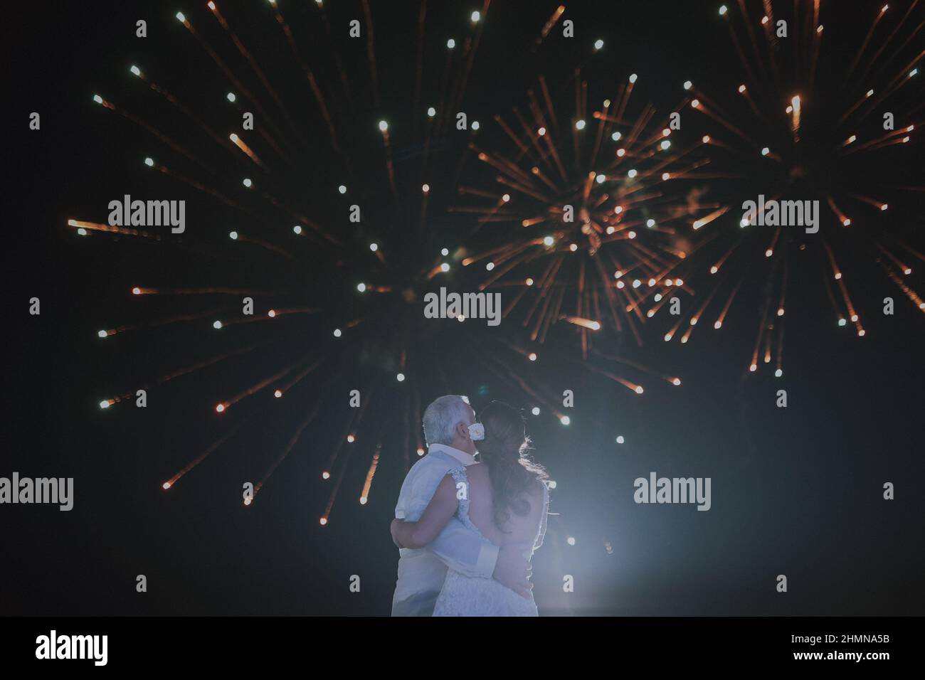 Couple watching their fireworks display Stock Photo - Alamy