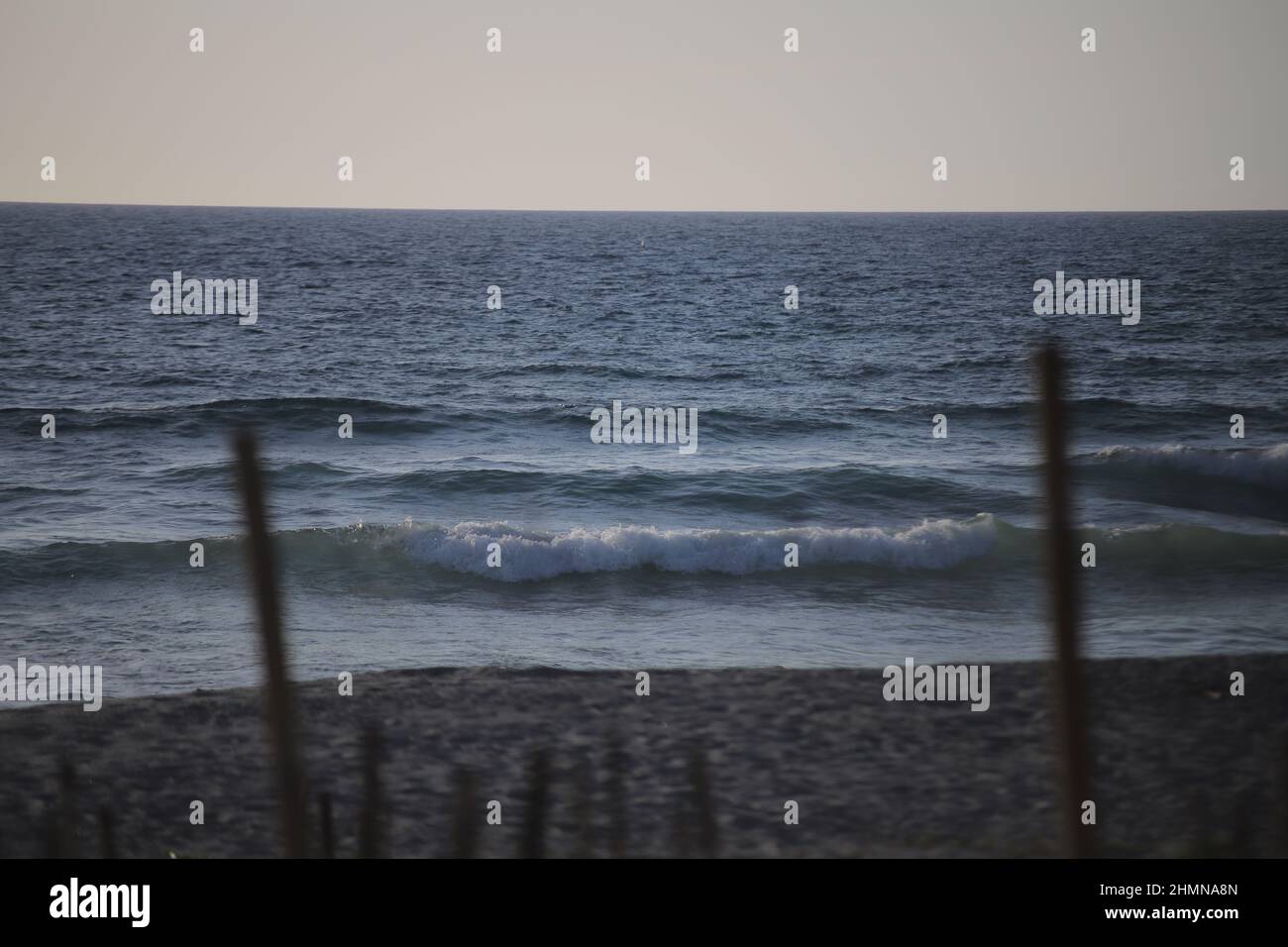 a very calm sea with small waves Stock Photo - Alamy