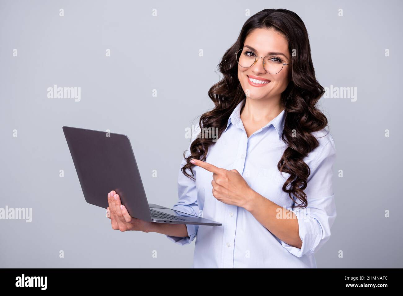 Photo of cheerful promoter lady direct finger netbook pc wear eyewear ...