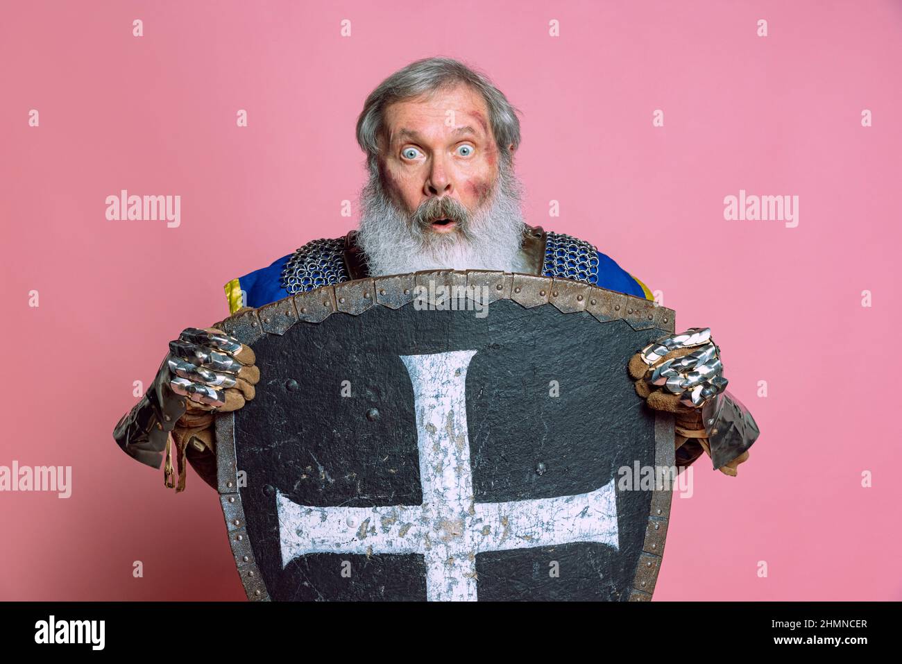 Shock. Portrait of senior grey bearded man, brave medieval warrior or ...