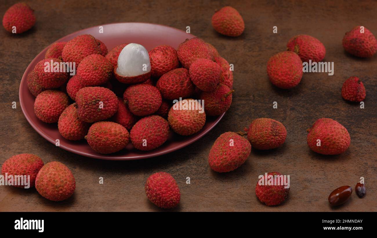 The photo shows tropical red fruits - lychee. Exotic food is set ...