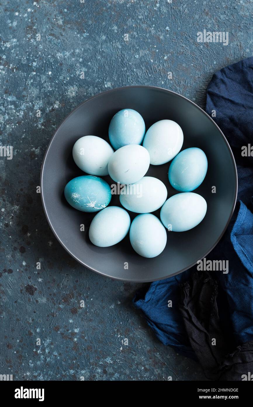 Blue Easter eggs painted with natural dye red cabbage on dark blue ...