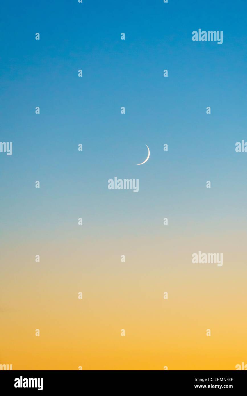 Crescent at the sunset sky. Sunset colors and new moon Stock Photo - Alamy