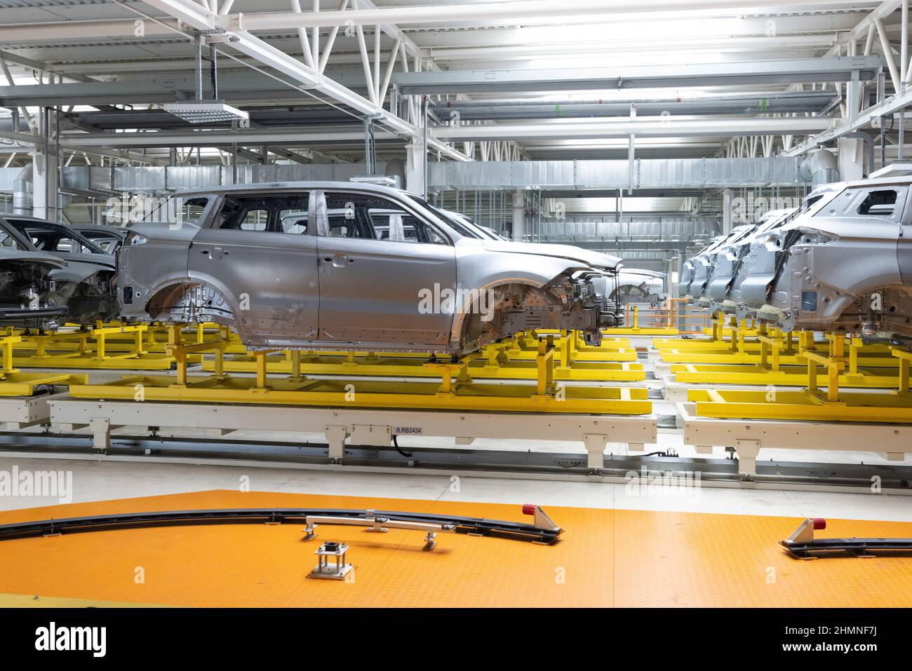 Car bodies are on assembly line. Factory for production of cars. Modern ...